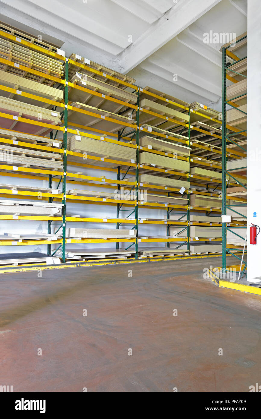 Wood planks and building materials in warehouse Stock Photo - Alamy