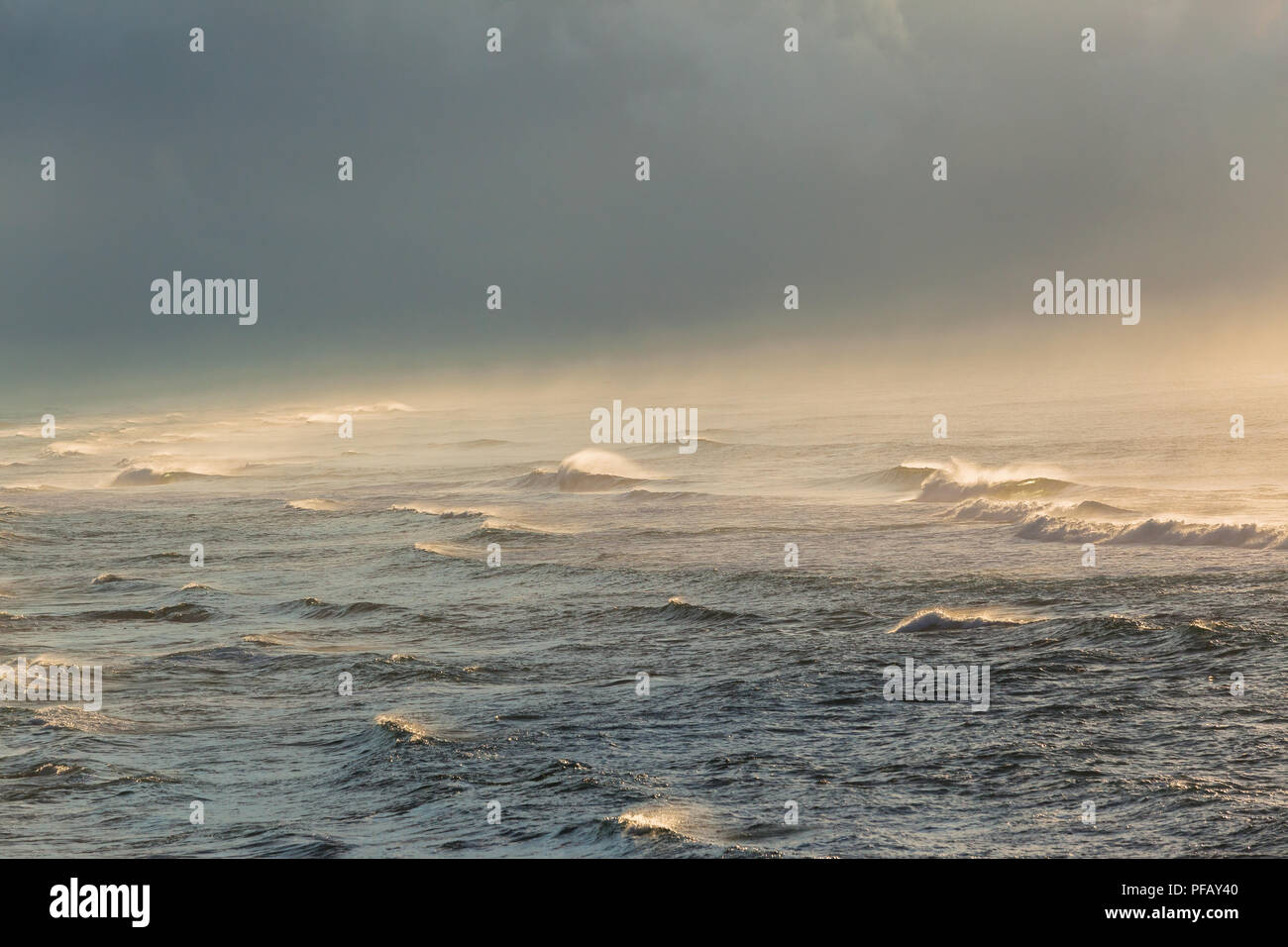 Ocean waves with dark weather clouds on horizon for moody moment in ...