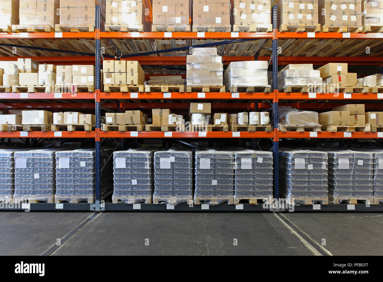 Mobile shelving system with goods in warehouse Stock Photo - Alamy