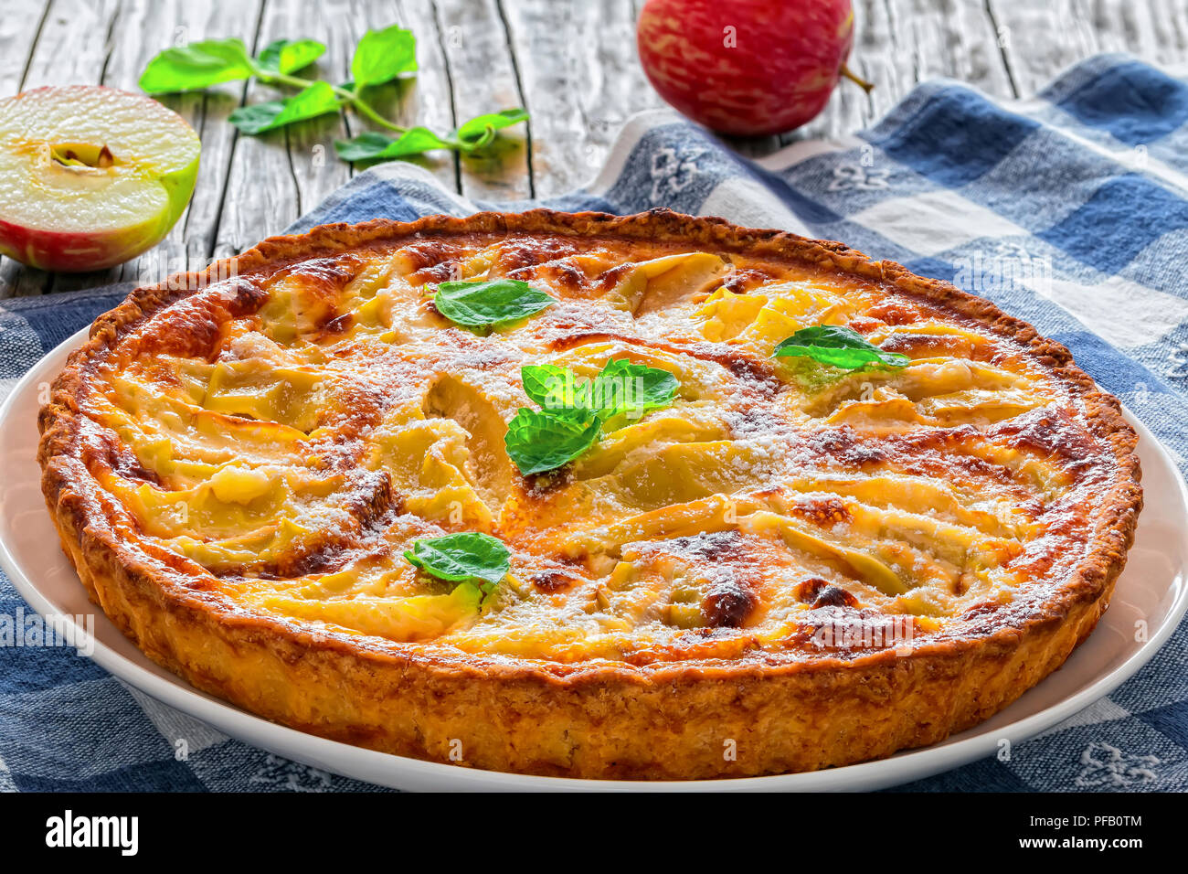 Homemade apple pie sprinkled with icing sugar decorated with mint ...