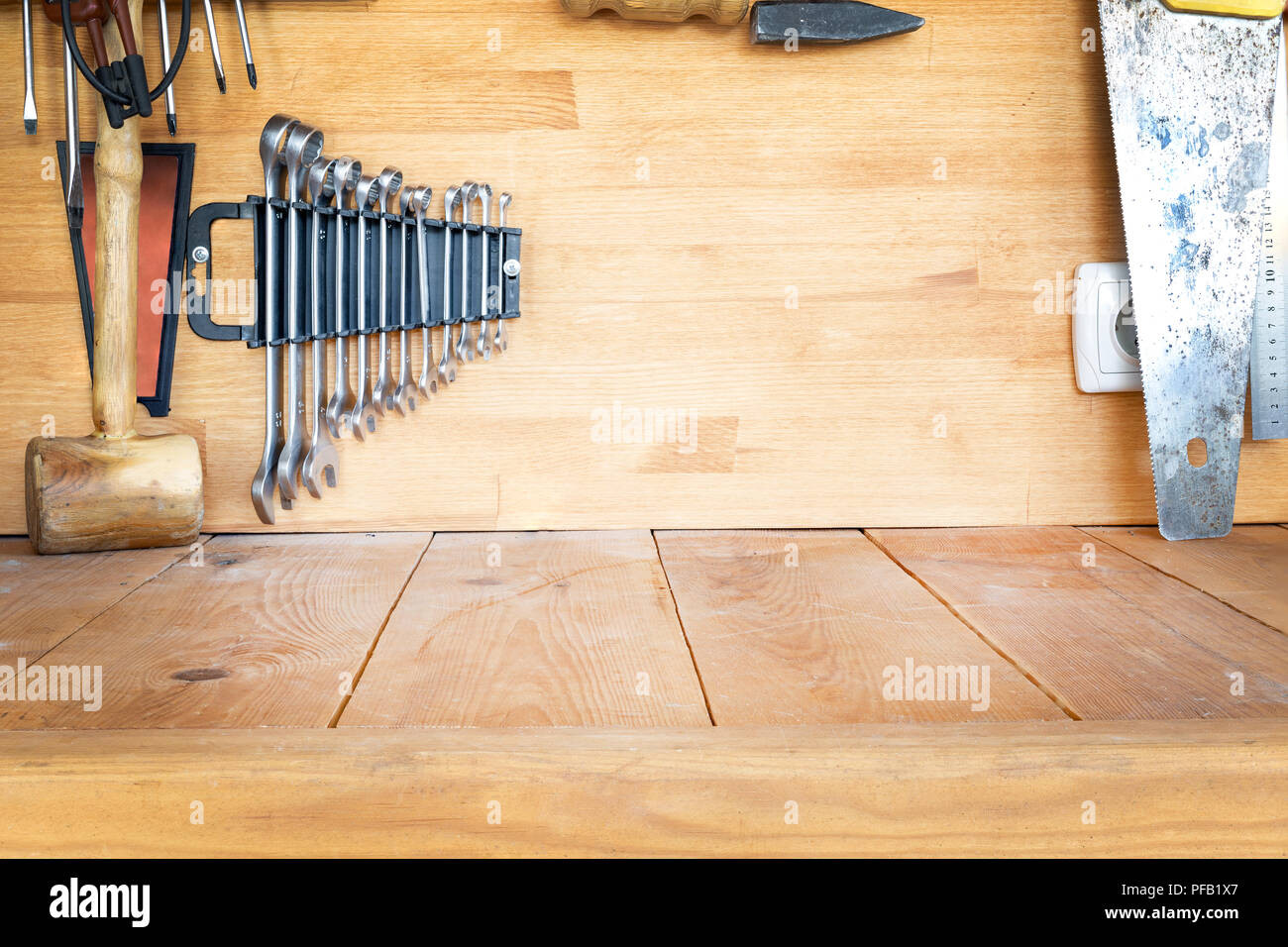 Wooden workbench at workshop. Lot of different tools for diy and repair ...