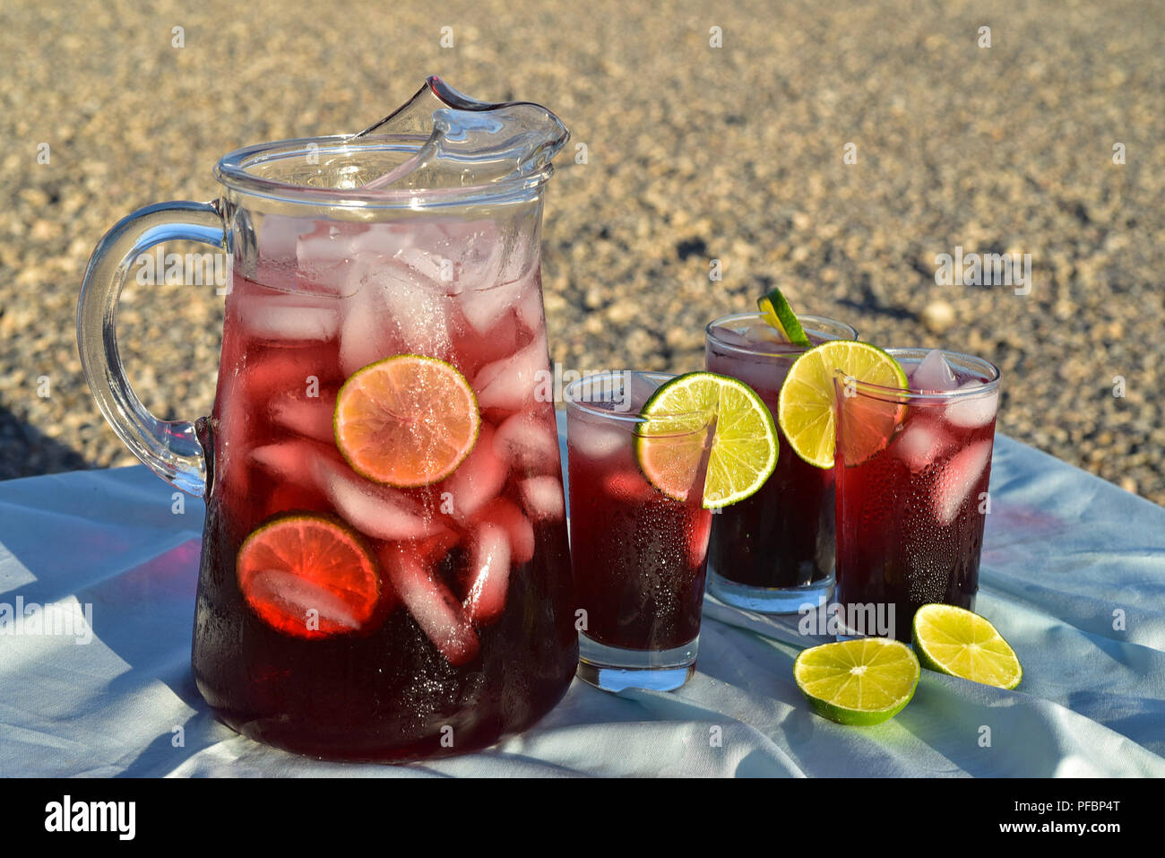 colorful red Hibiscus flower petal iced tea in drinking glasses and ...