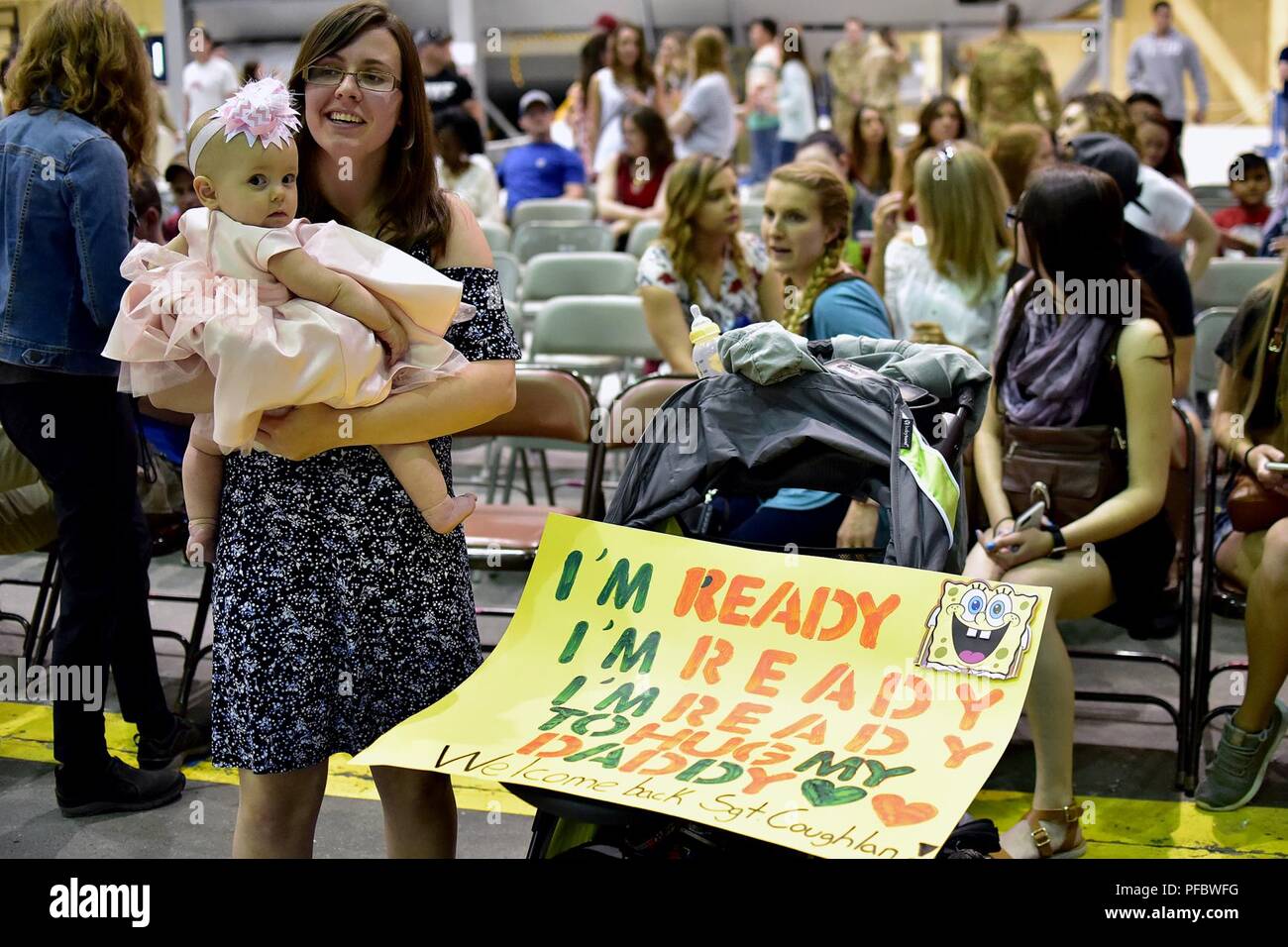 Amanda Coughlan and her daughter, Evelynn, wait for the return of her ...