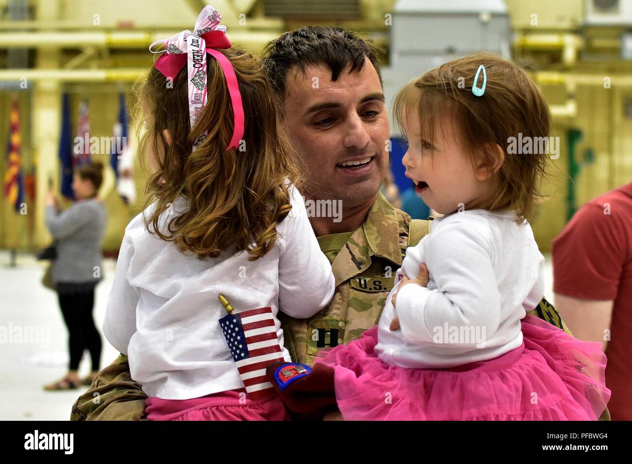 Capt. John Tilley is greeted by his daughters, Frances, 1, and Grace, 3 ...