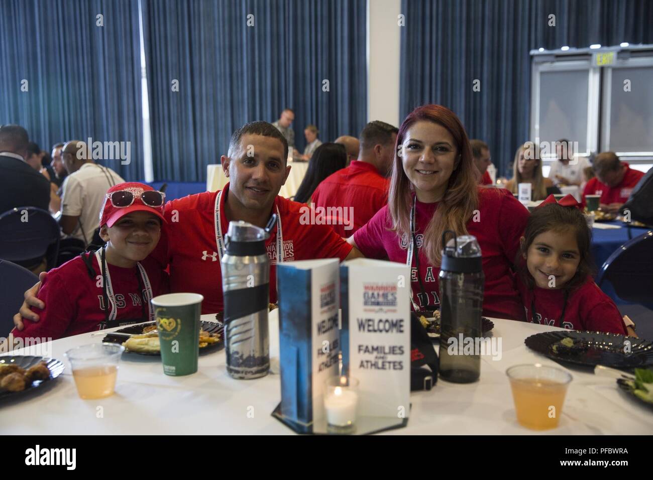 U.S. Marine Corps Gunnery Sgt. Alexis Padilla sits with his family ...