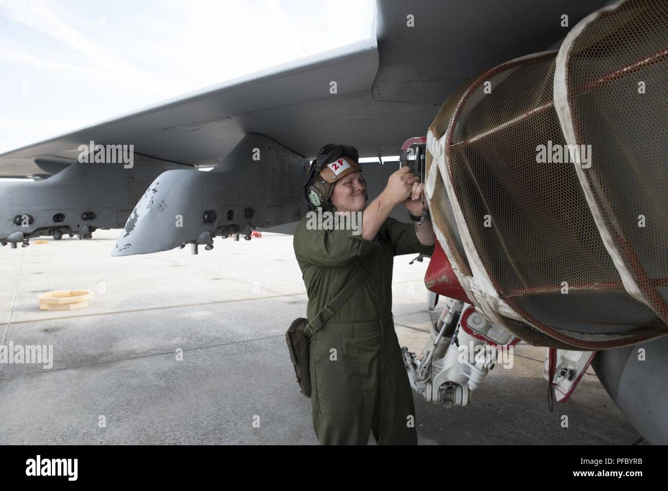 Lance Cpl. Hunter Cauthron places a screen over the engine intake of an ...