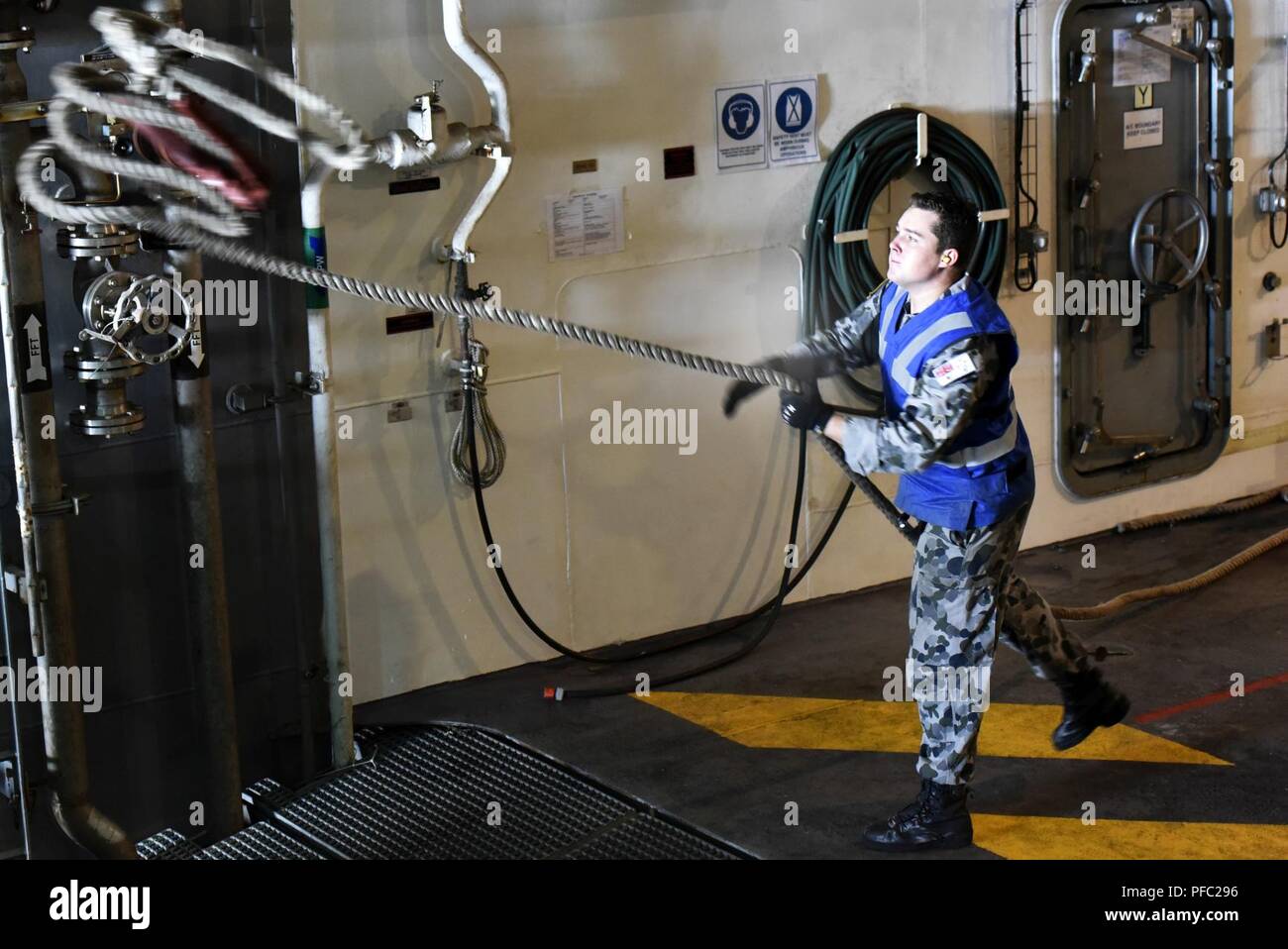 Australian Defence Force Able Seaman Logan prepares to tie a Light ...