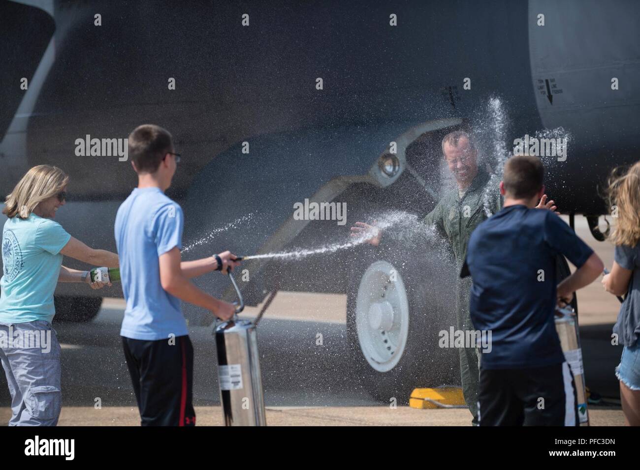 Col. Ty Neuman, 2nd Bomb Wing commander, is sprayed by his wife and ...