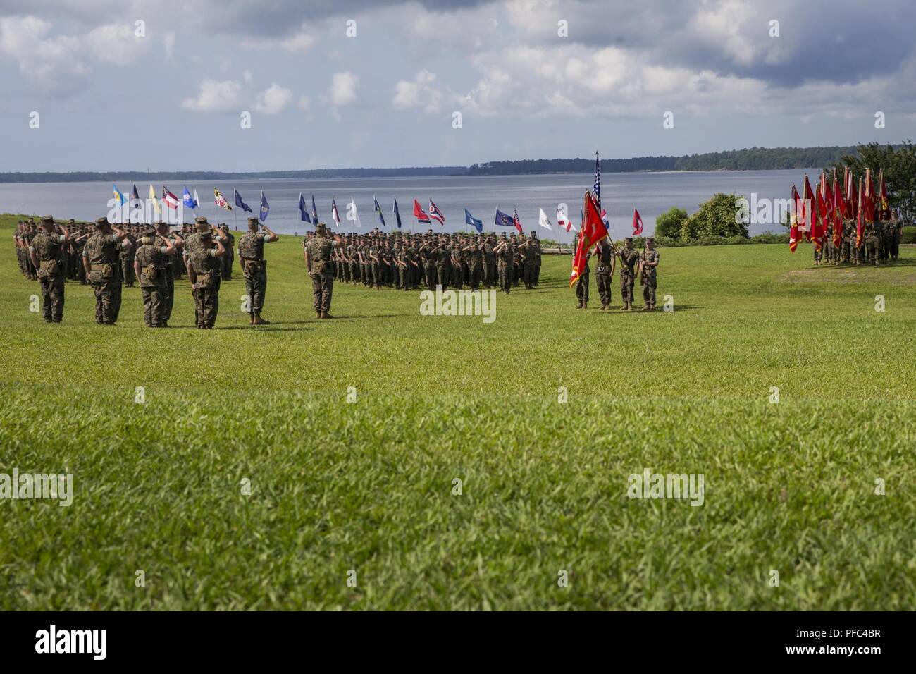 U.S. Marines and Sailors with 2nd Marine Logistics Group salute during ...