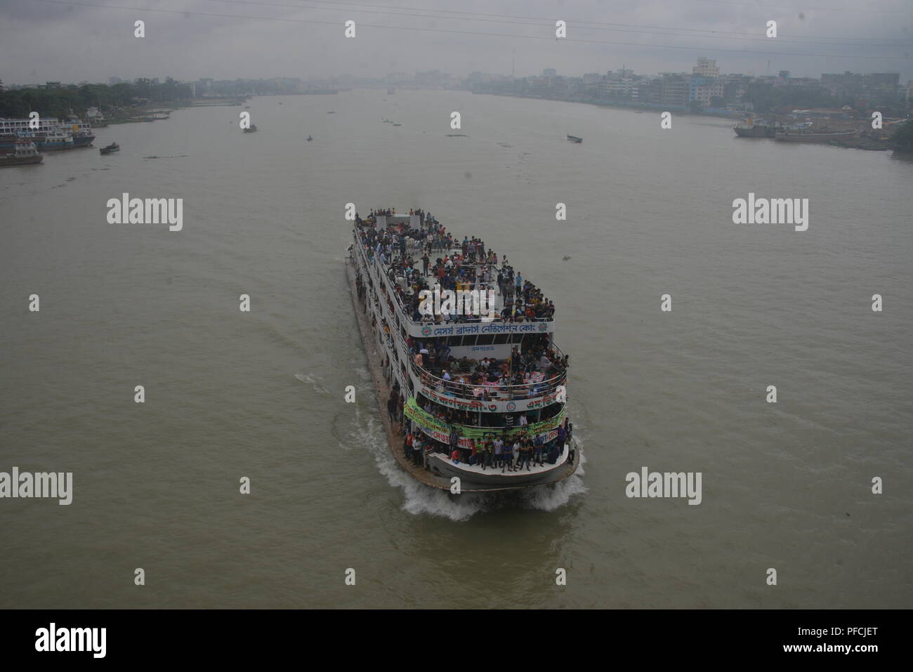 Dhaka. 21st Aug, 2018. A ferry packed with homebound travelers leaves ...
