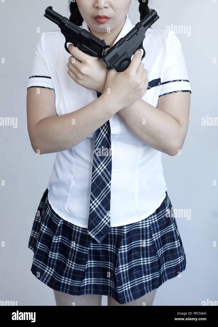 Girl holding guns hi-res stock photography and images - Alamy