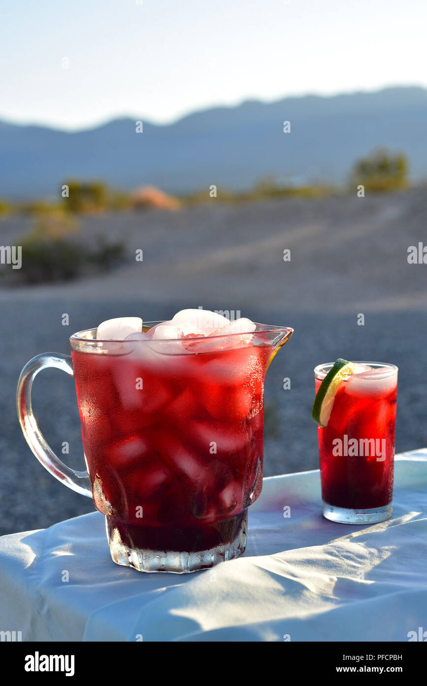 colorful red Hibiscus flower petal iced tea in drinking glasses and ...