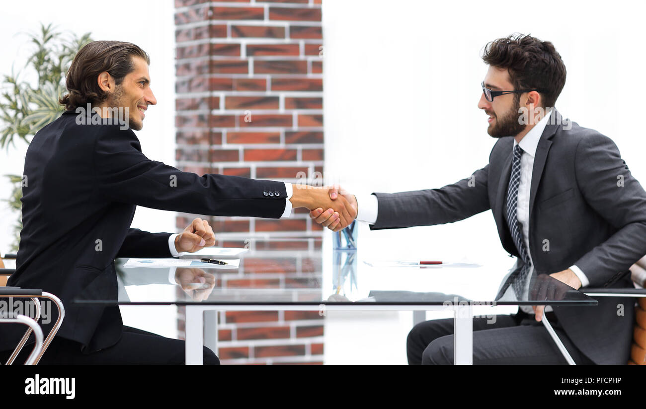 handshake Manager and the client sitting in the office Stock Photo - Alamy