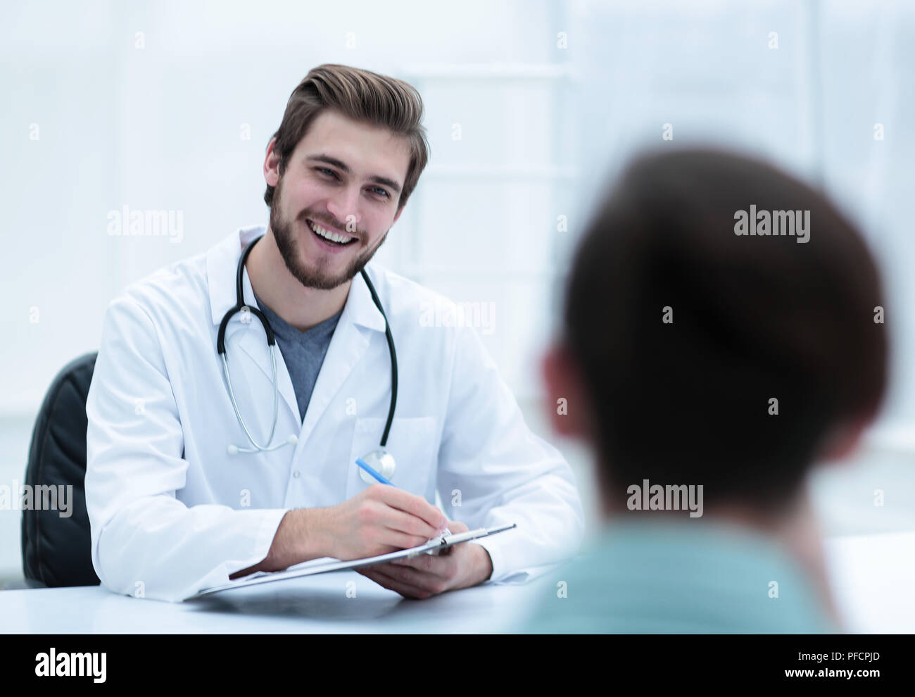 closeup.doctor writing a prescription to her patient Stock Photo - Alamy