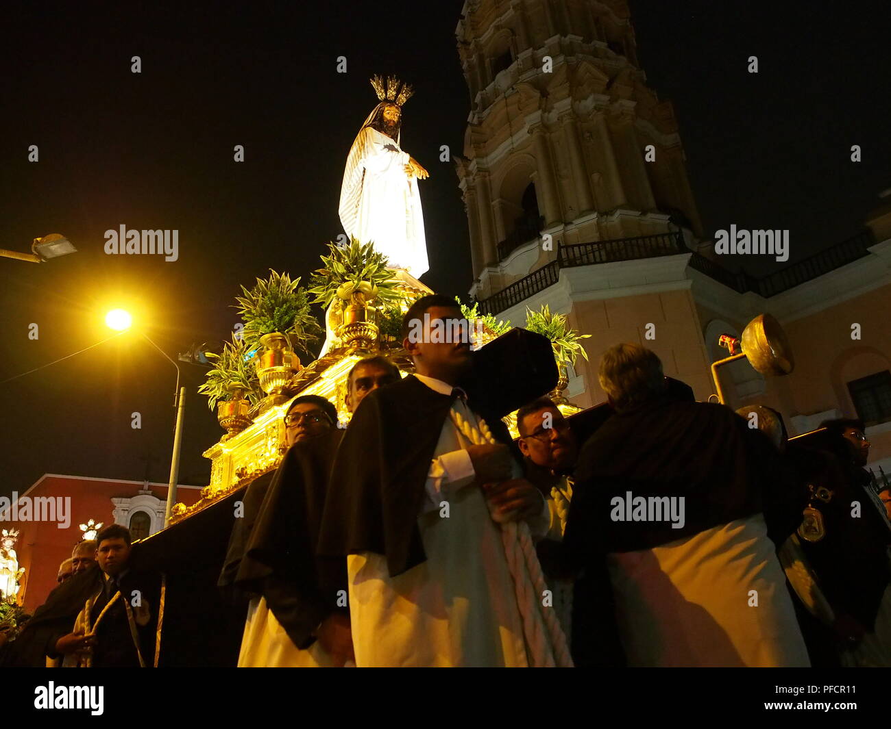 Devotees carrying on a religious procession at night called: "Steps of ...