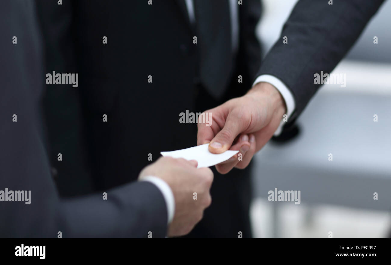 businessman handing business card to the partner Stock Photo - Alamy