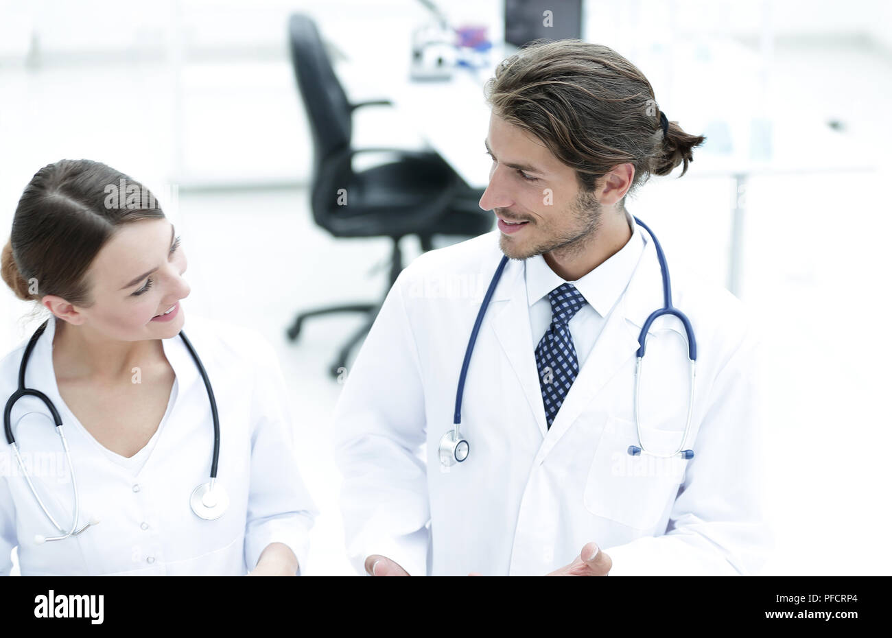 Two Doctors Having Meeting In Hospital Reception Area Stock Photo - Alamy