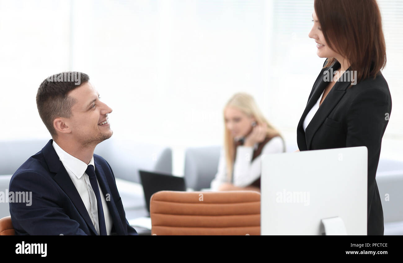 employees sitting behind a Desk in the office Stock Photo - Alamy