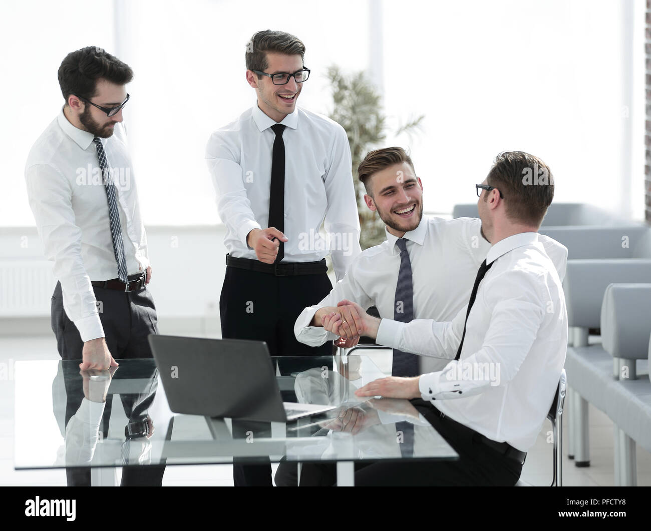 happy employees shaking hands Stock Photo - Alamy
