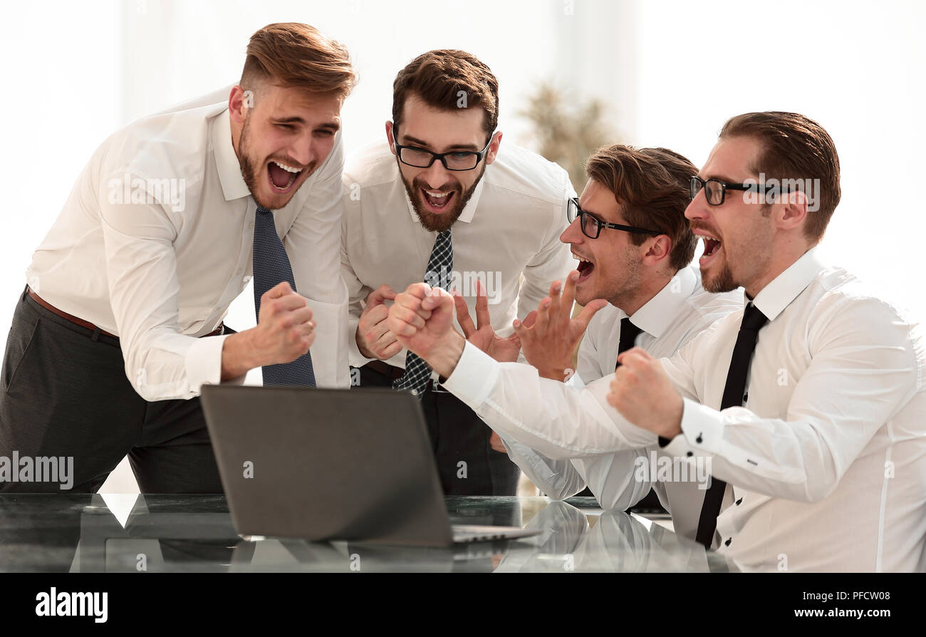 very happy business team standing near the desktop Stock Photo - Alamy