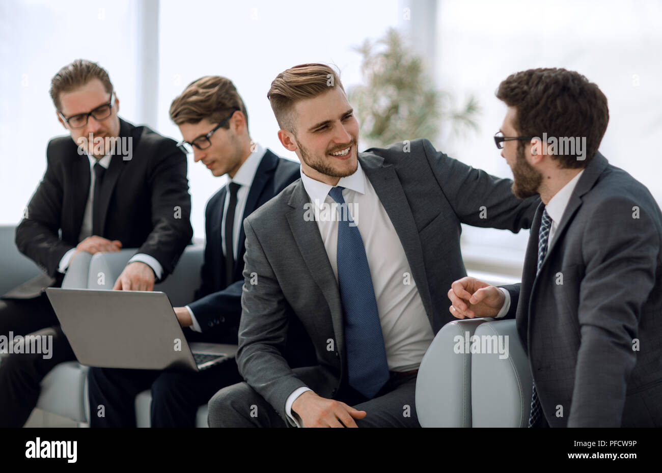 business colleagues talk sitting in the office lobby Stock Photo - Alamy
