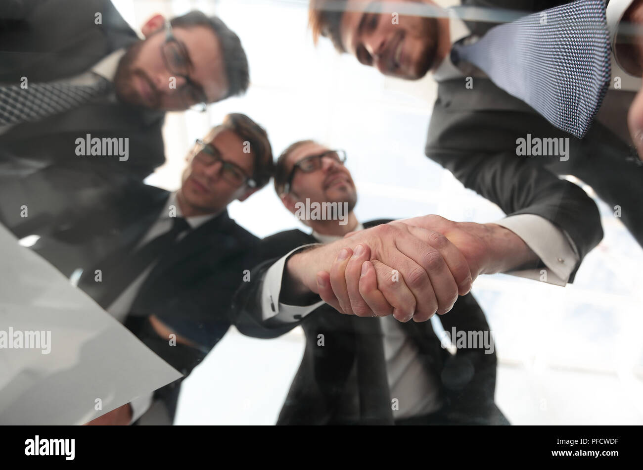 business people shaking hands over the office Desk Stock Photo - Alamy