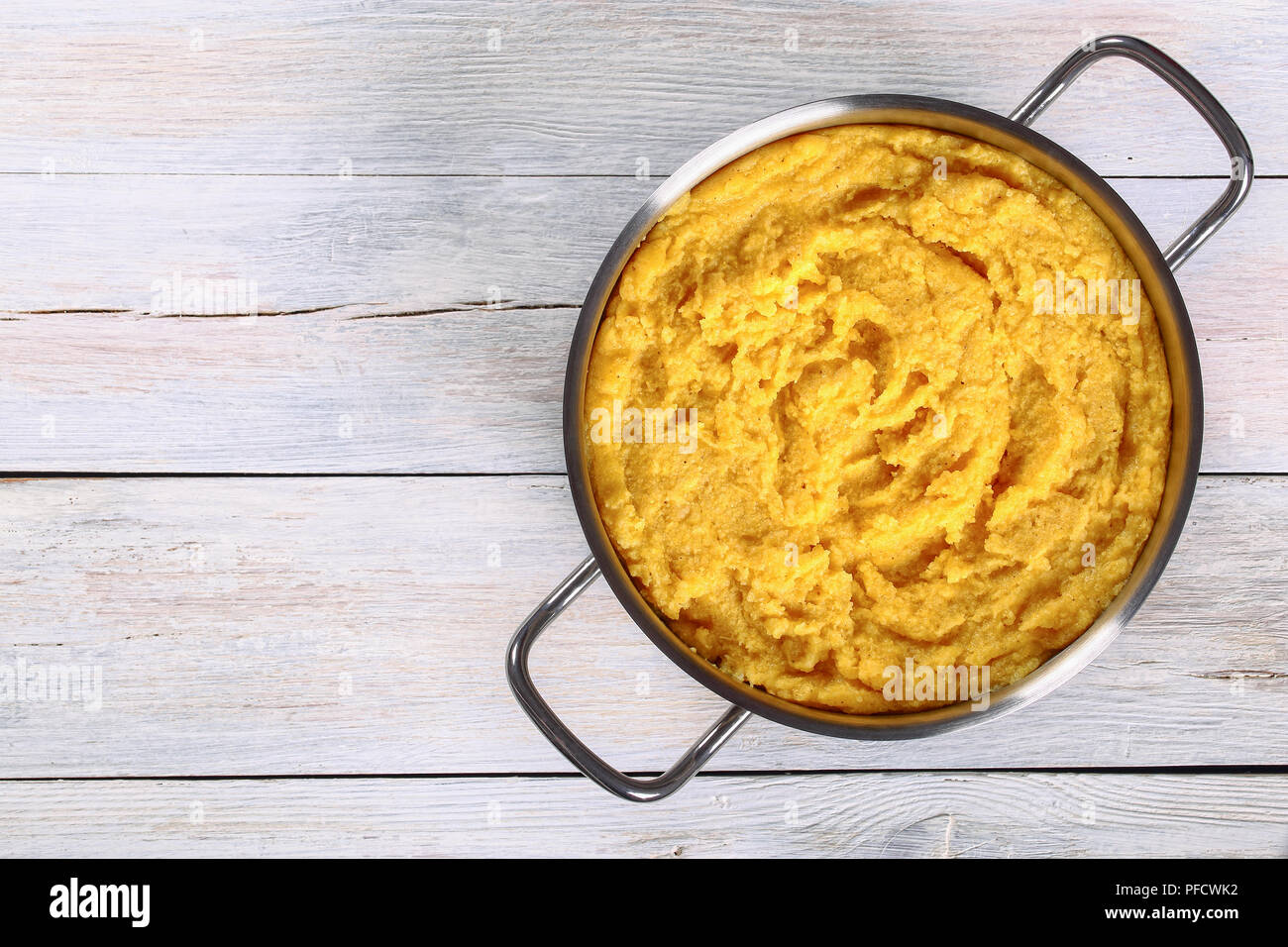 basic polenta in pan on white wooden table, authentic italian recipe ...