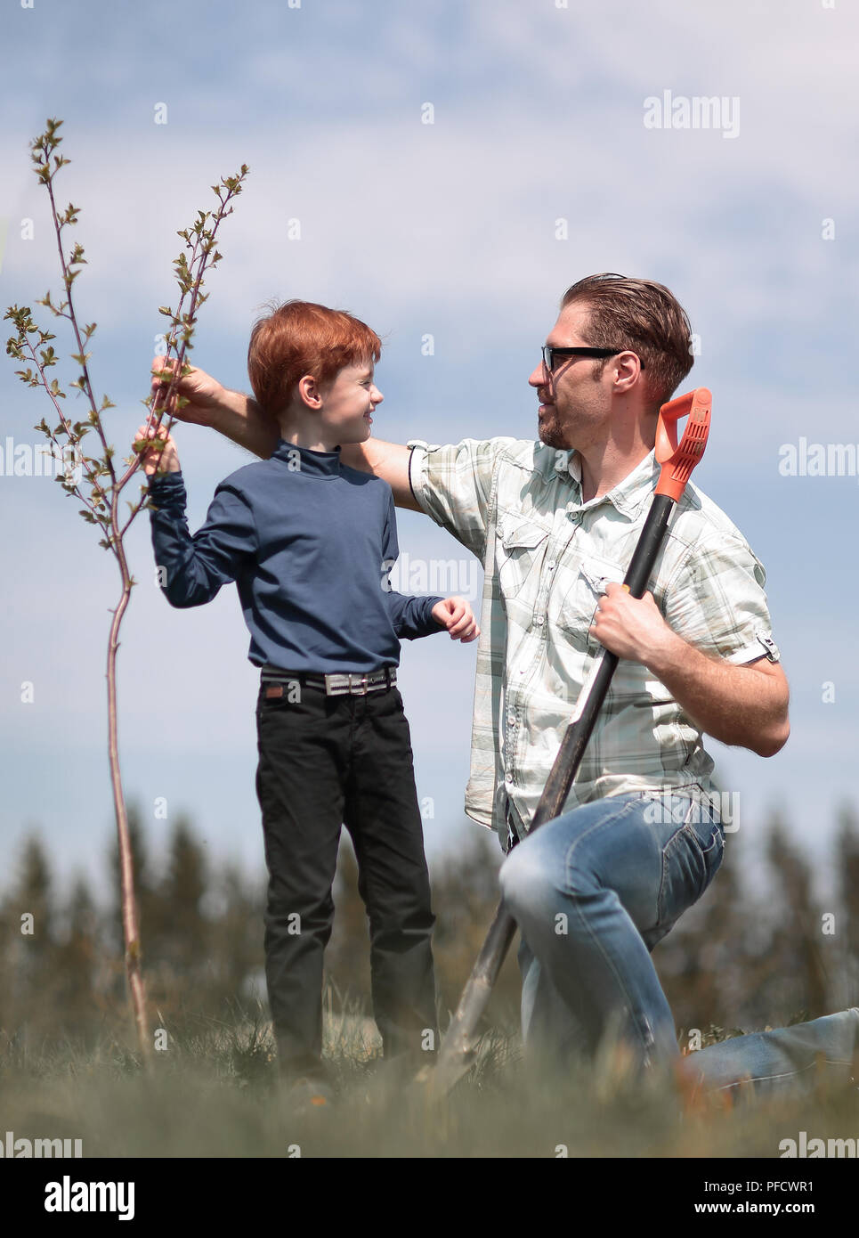 happy father and son planted a tree together Stock Photo - Alamy