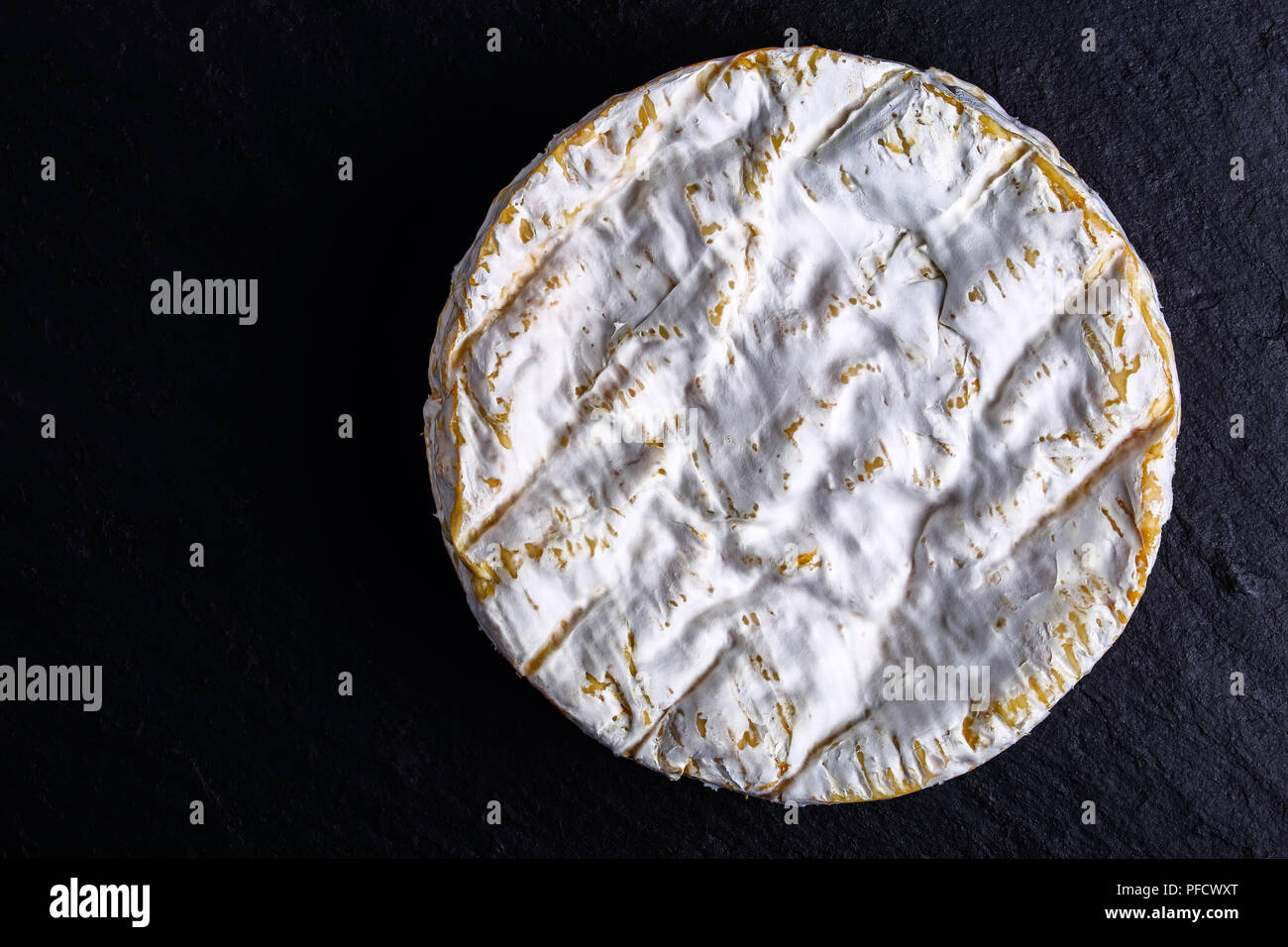 soft, creamy, surface-ripened cow's milk cheese Camembert on black ...