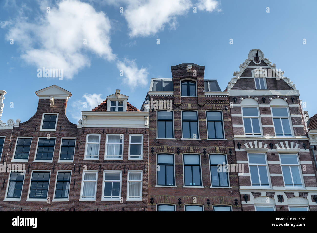 Traditional old buildings in Amsterdam, the Netherlands with blue sky ...