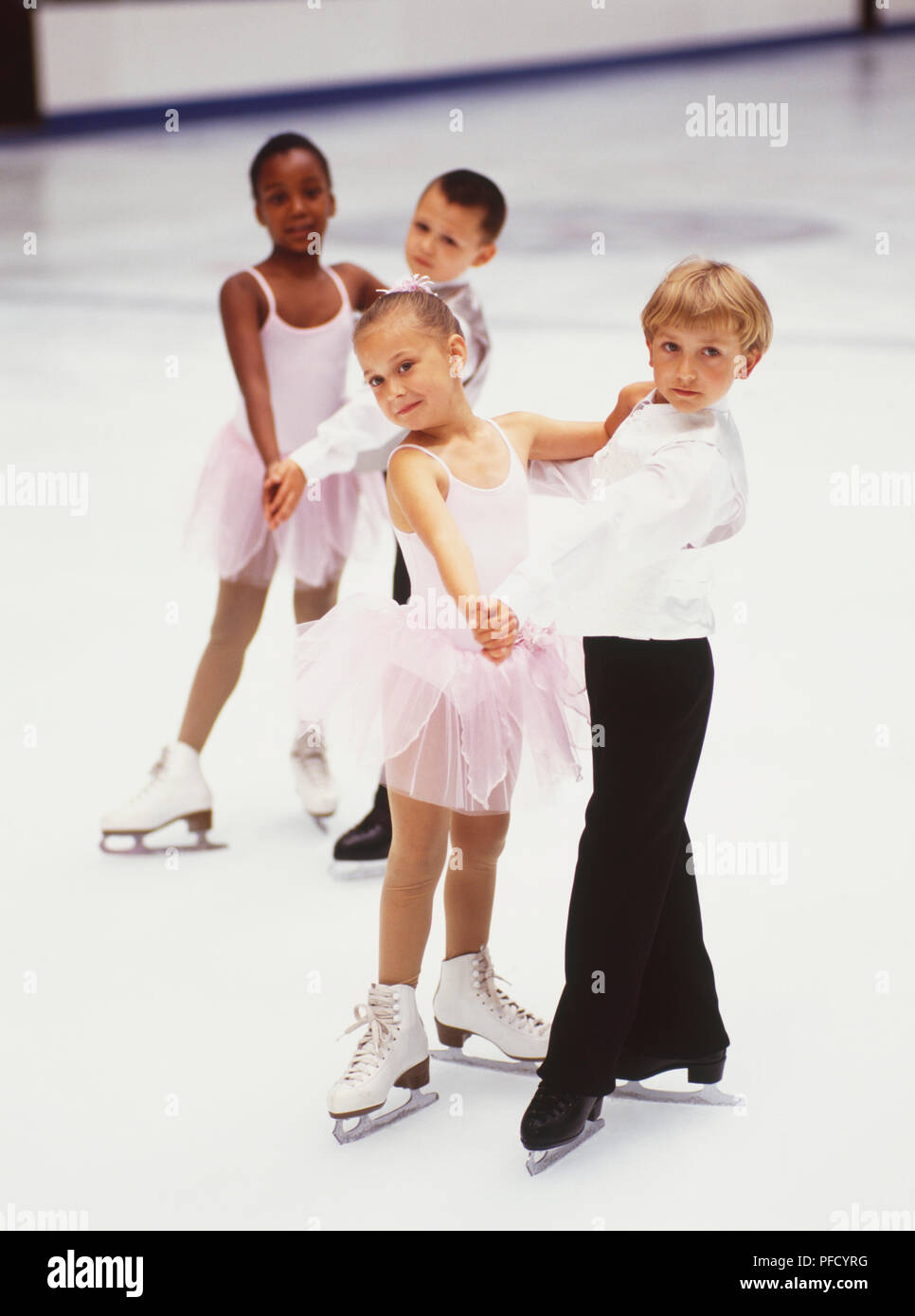Two young ice skating couples about to perform Stock Photo - Alamy