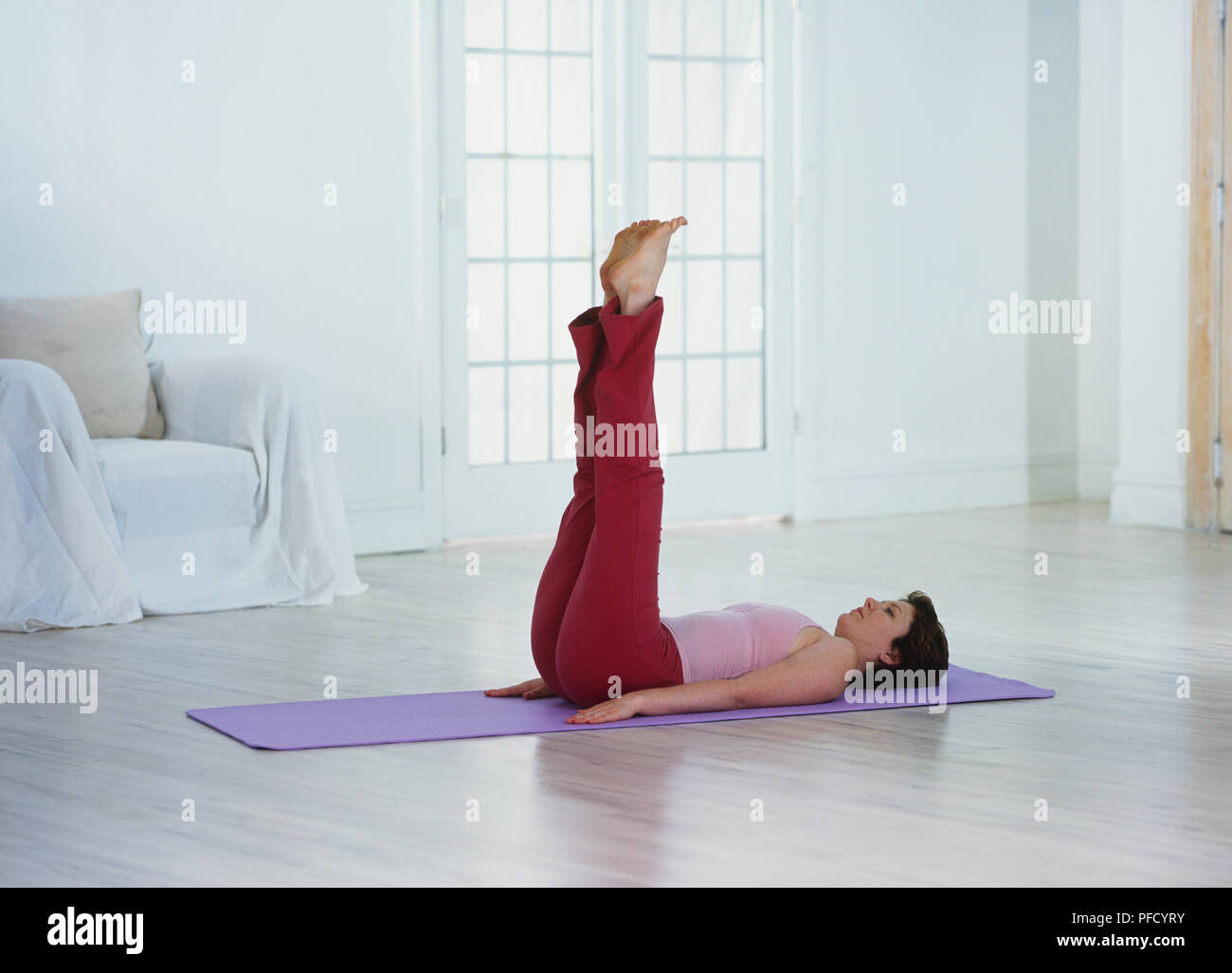 Woman lying on back legs up hi-res stock photography and images - Alamy