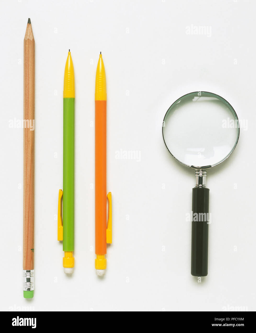 Pencil, two mechanical pencils, magnifying glass Stock Photo - Alamy