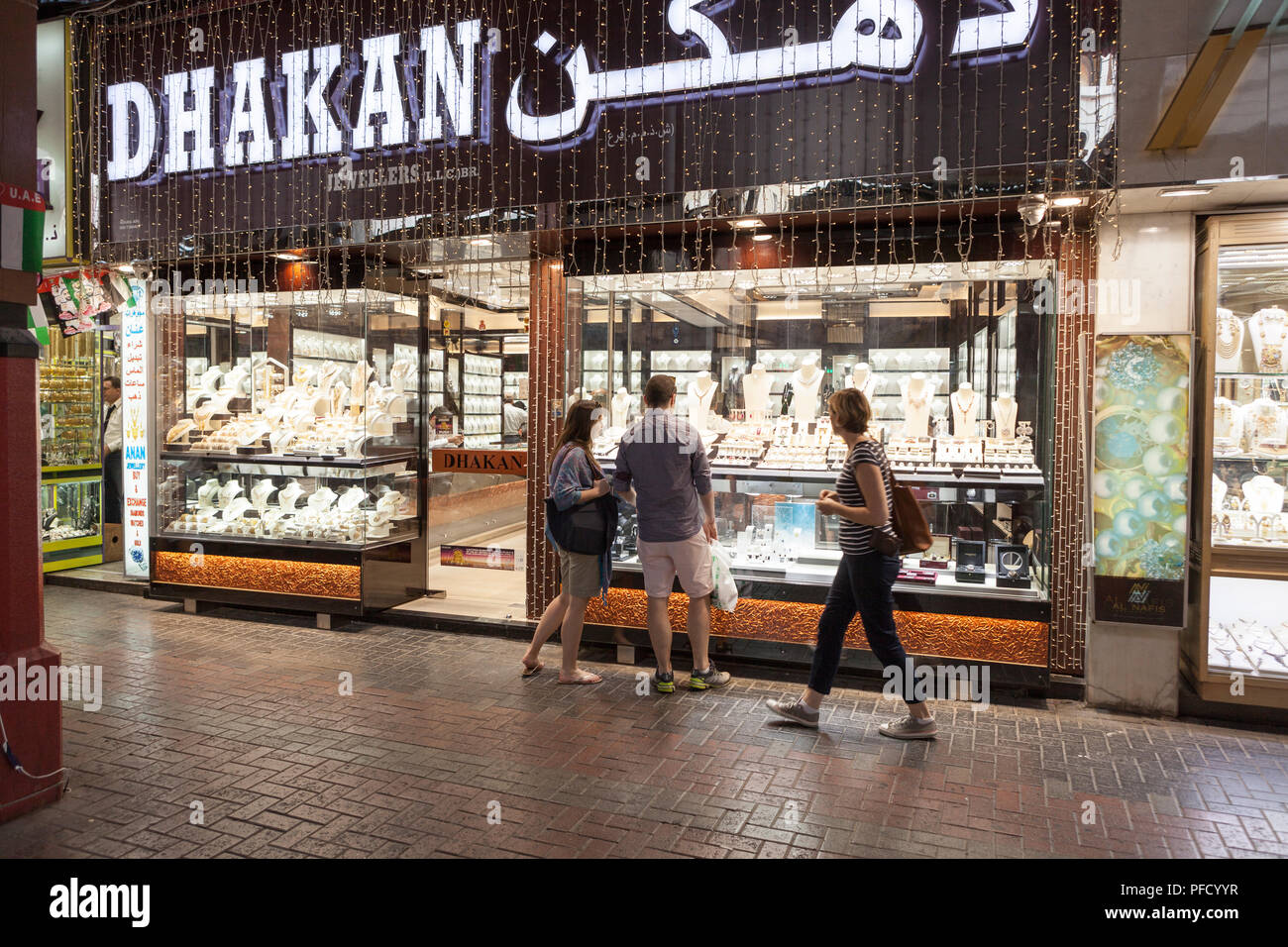Tourists looking at the window displays at a jewellery store in the ...
