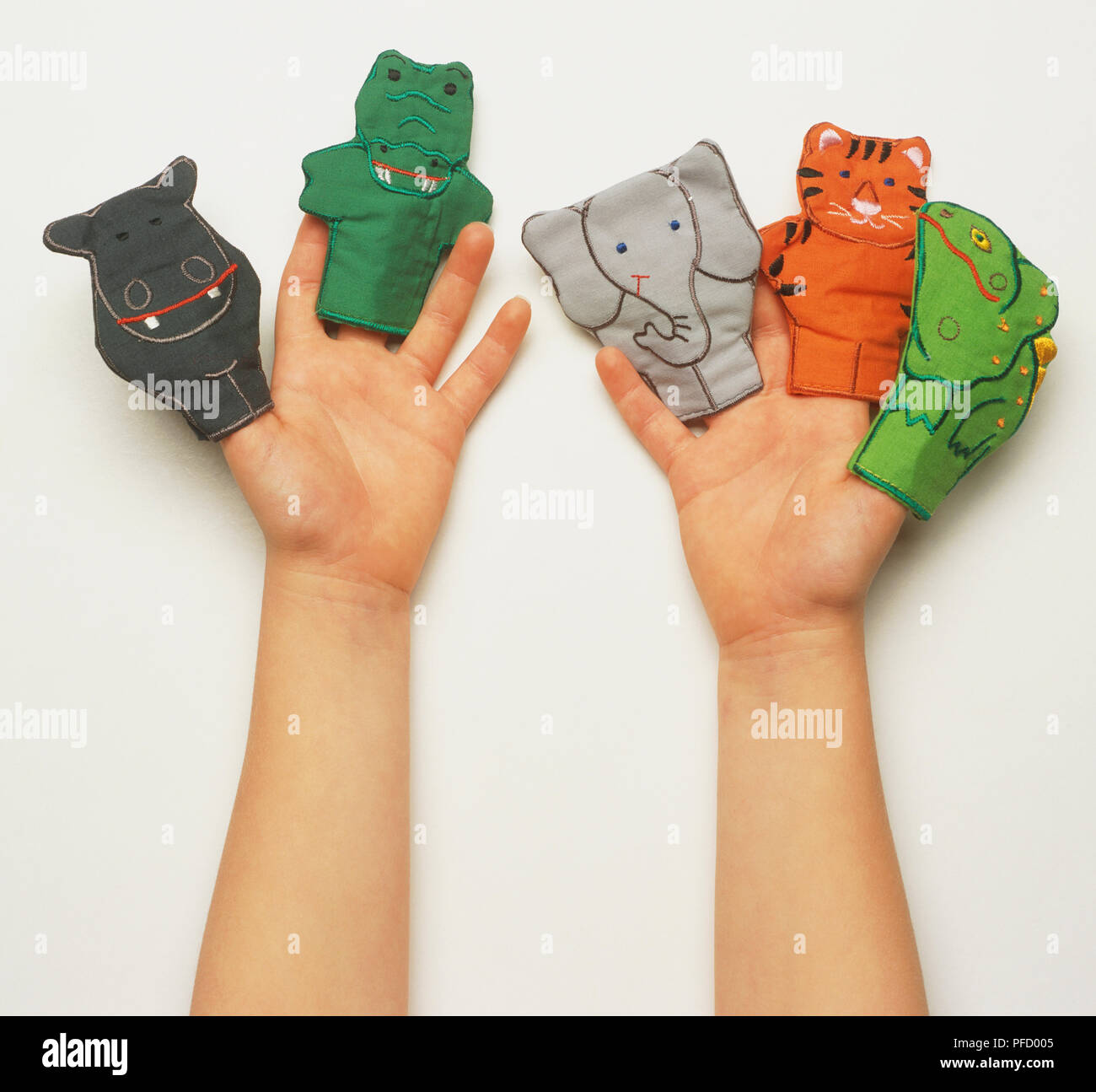 Pair of hands displaying finger-sized animal puppets with palms facing ...