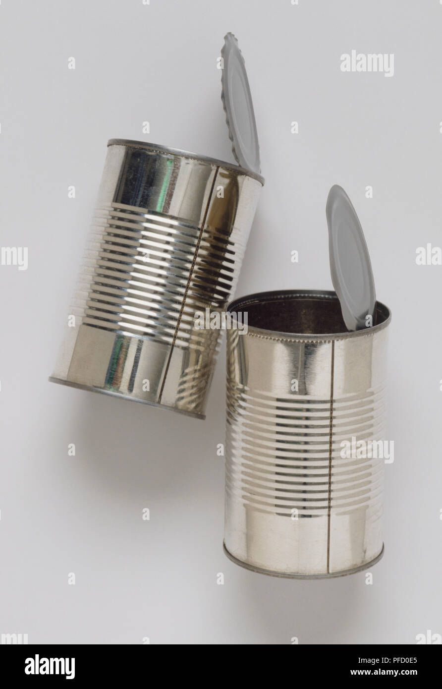 Two unlabelled opened tin cans, side view Stock Photo - Alamy