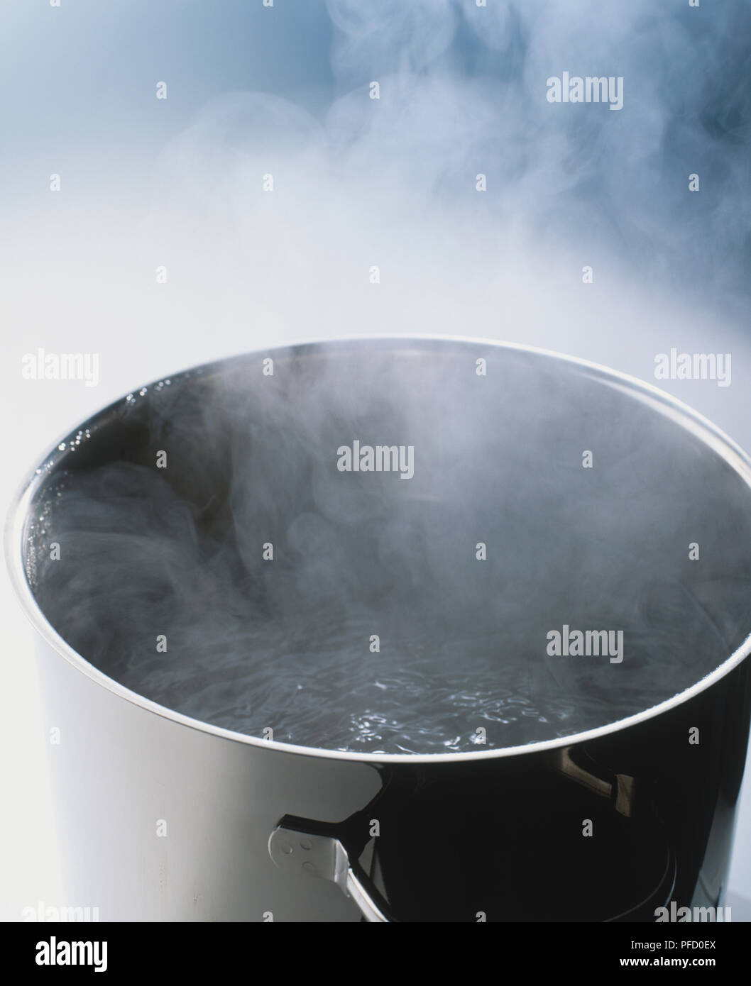 Steaming water in metal pot, elevated view Stock Photo - Alamy