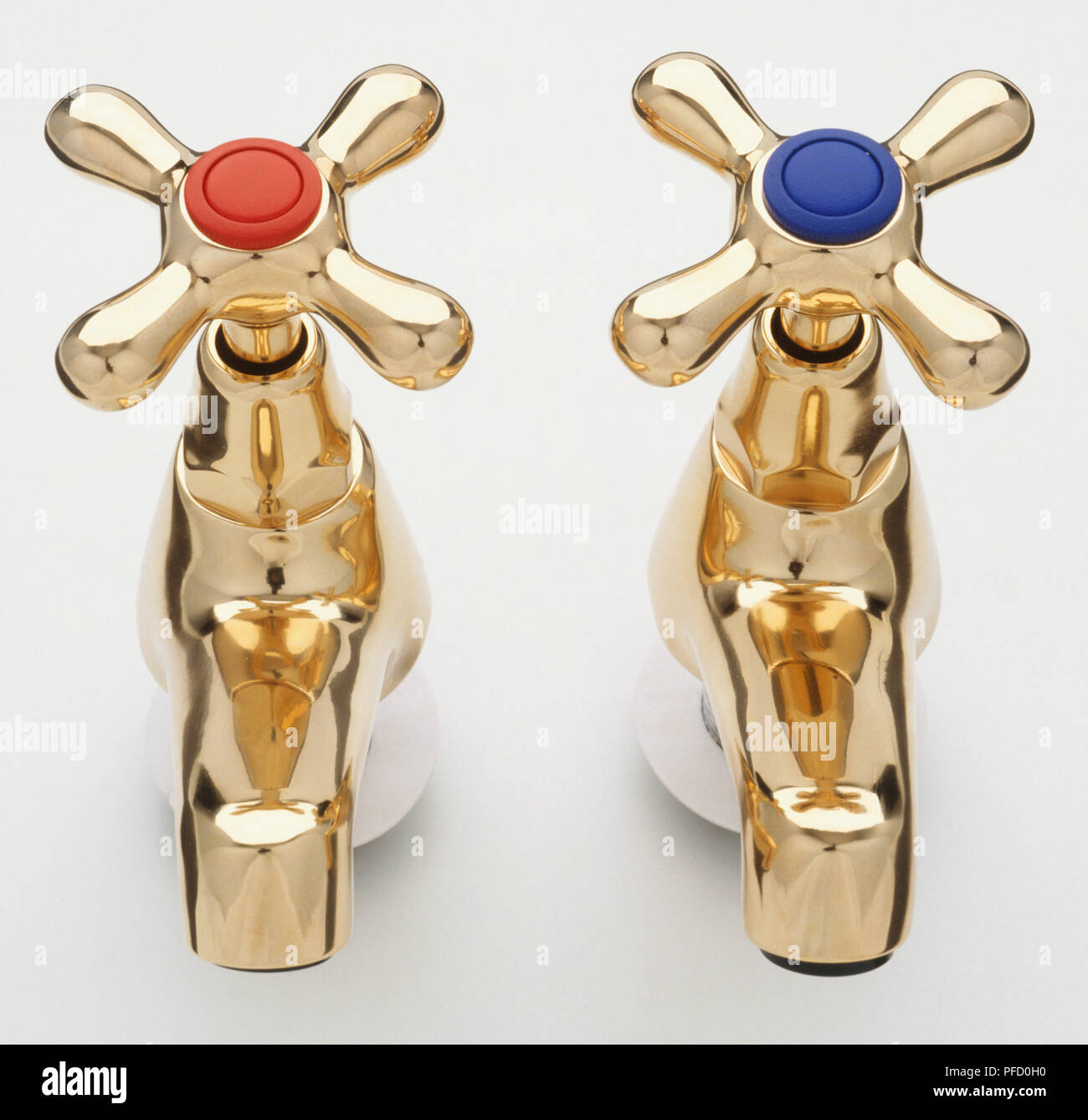 Two gold taps, one for hot and one for cold water, elevated view Stock ...