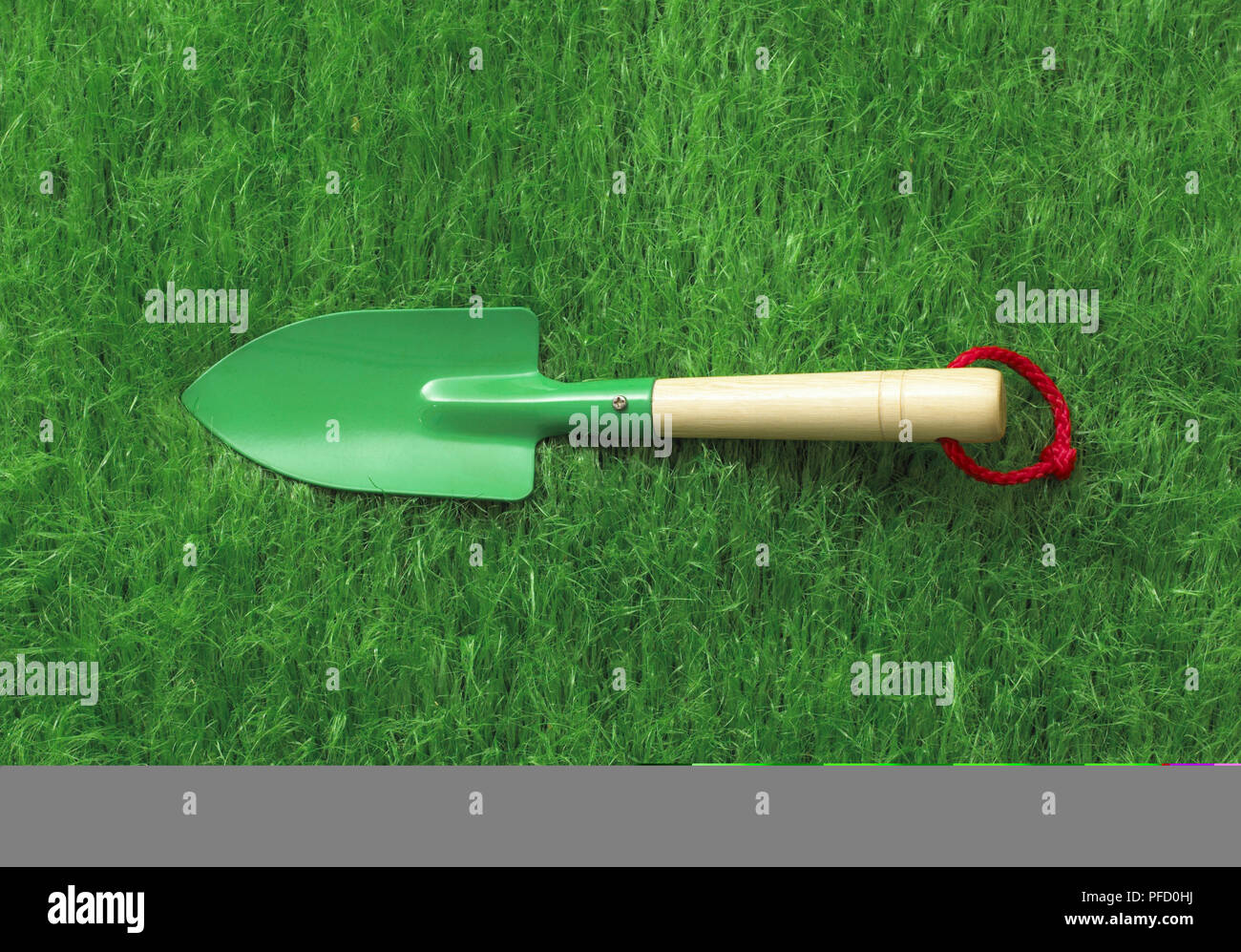 Green trowel with wooden handle on lawn, view from above Stock Photo ...
