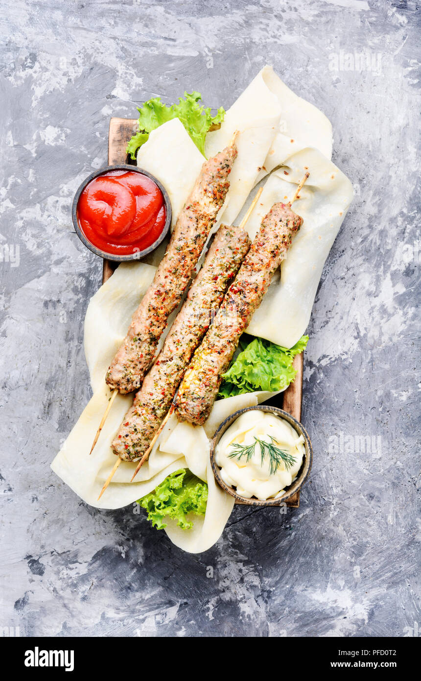 Turkish traditional dish meat kebab with herbs and spices.Caucasian ...