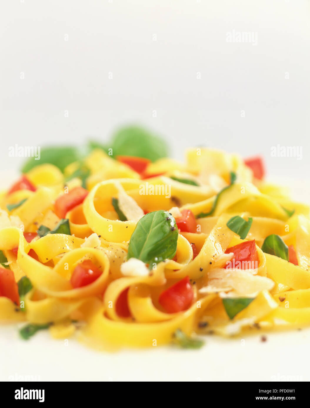 Tagliatelle pasta with sauce of finely chopped tomatoes, basil leaves ...