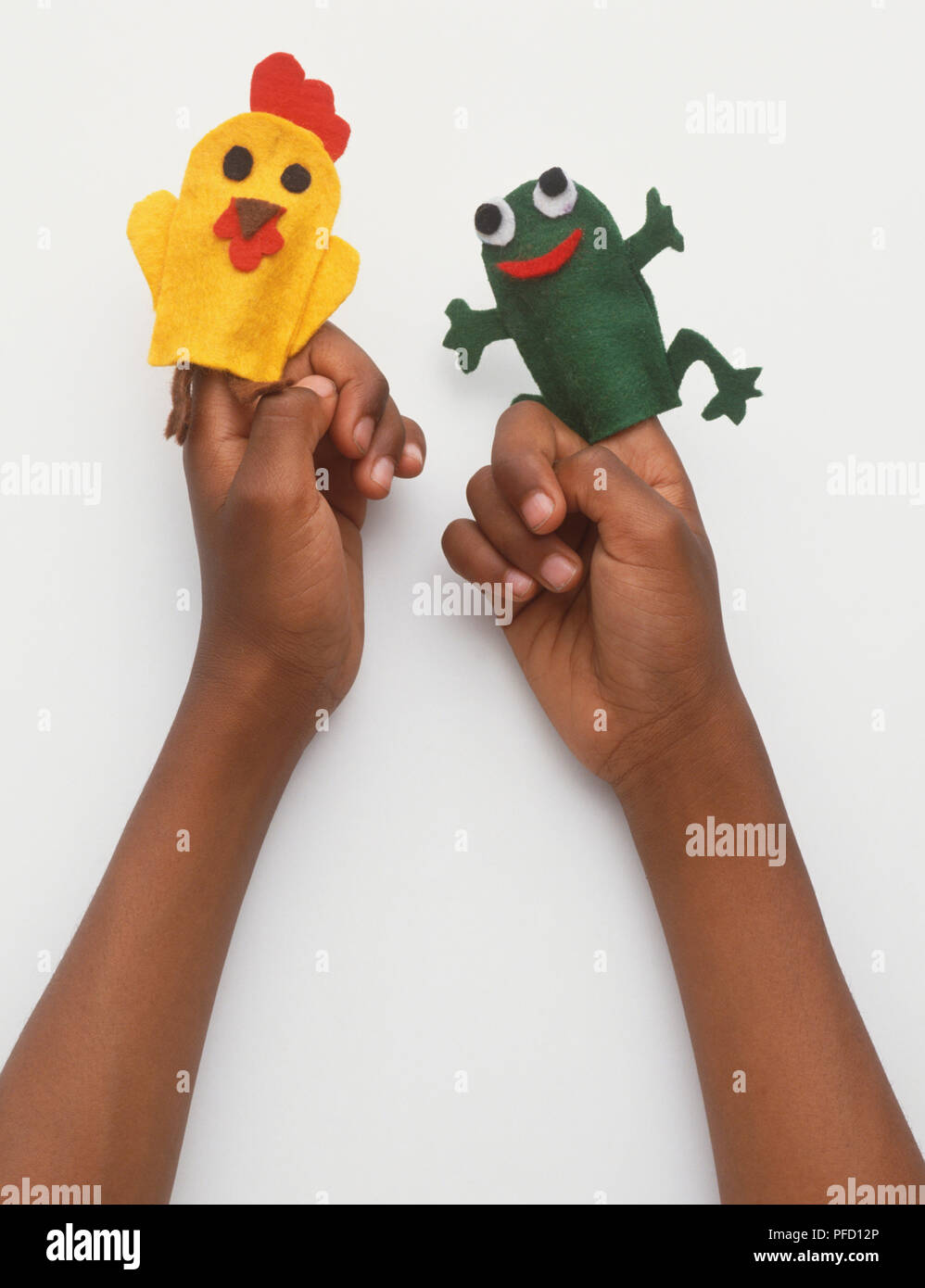 Cockerel and frog finger puppets slipped over index fingers Stock Photo ...