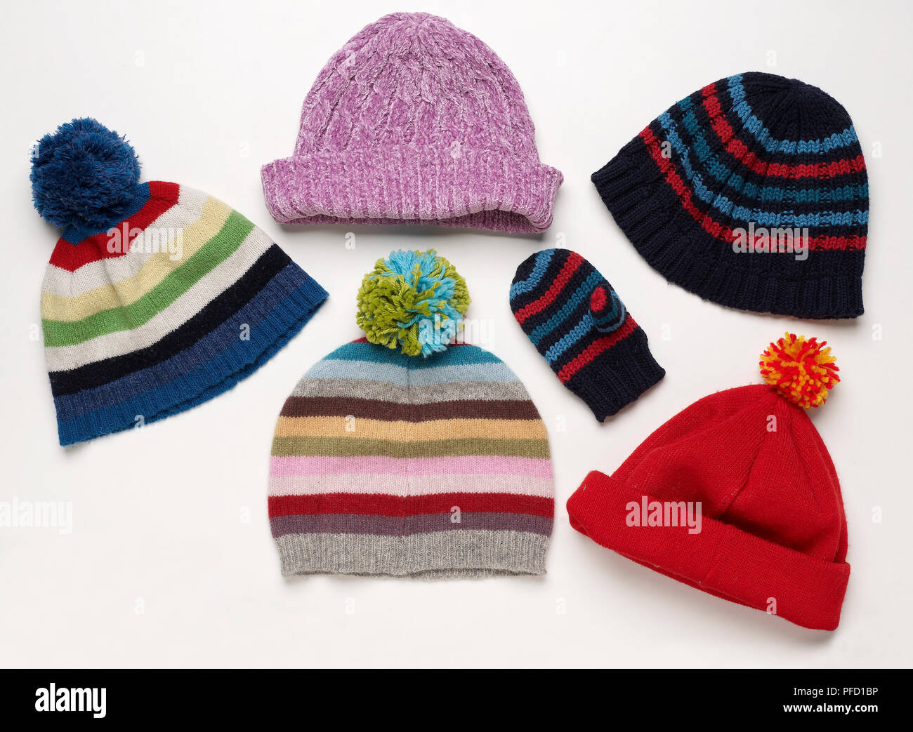 Collection of knitted bobble hats, woolly hats and one mitten Stock ...
