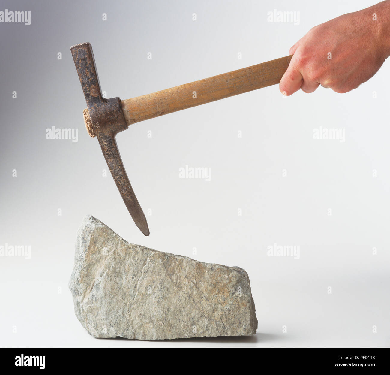 Pickaxe striking block of Granite Stock Photo - Alamy