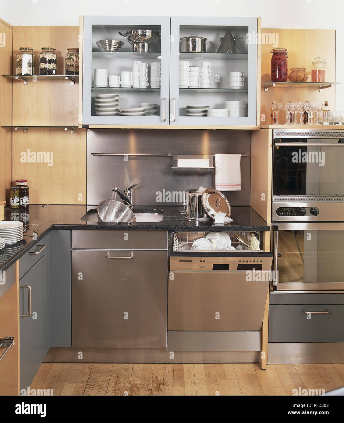 Fitted stainless steel dishwasher in shiny kitchen Stock Photo - Alamy