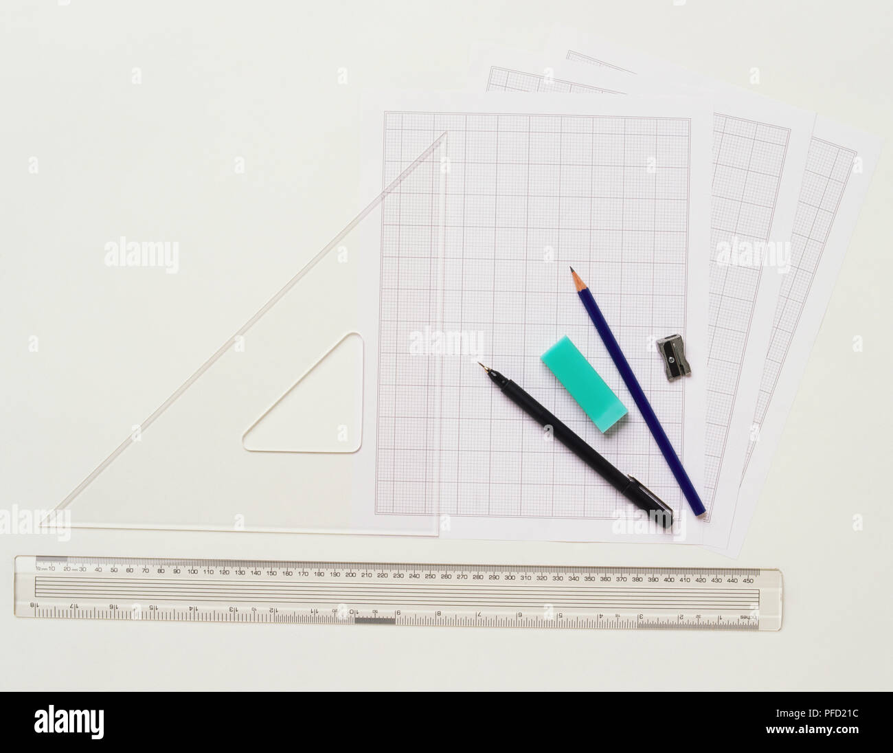 Graph paper, pen, eraser, pencil, pencil sharpener and rulers, view ...