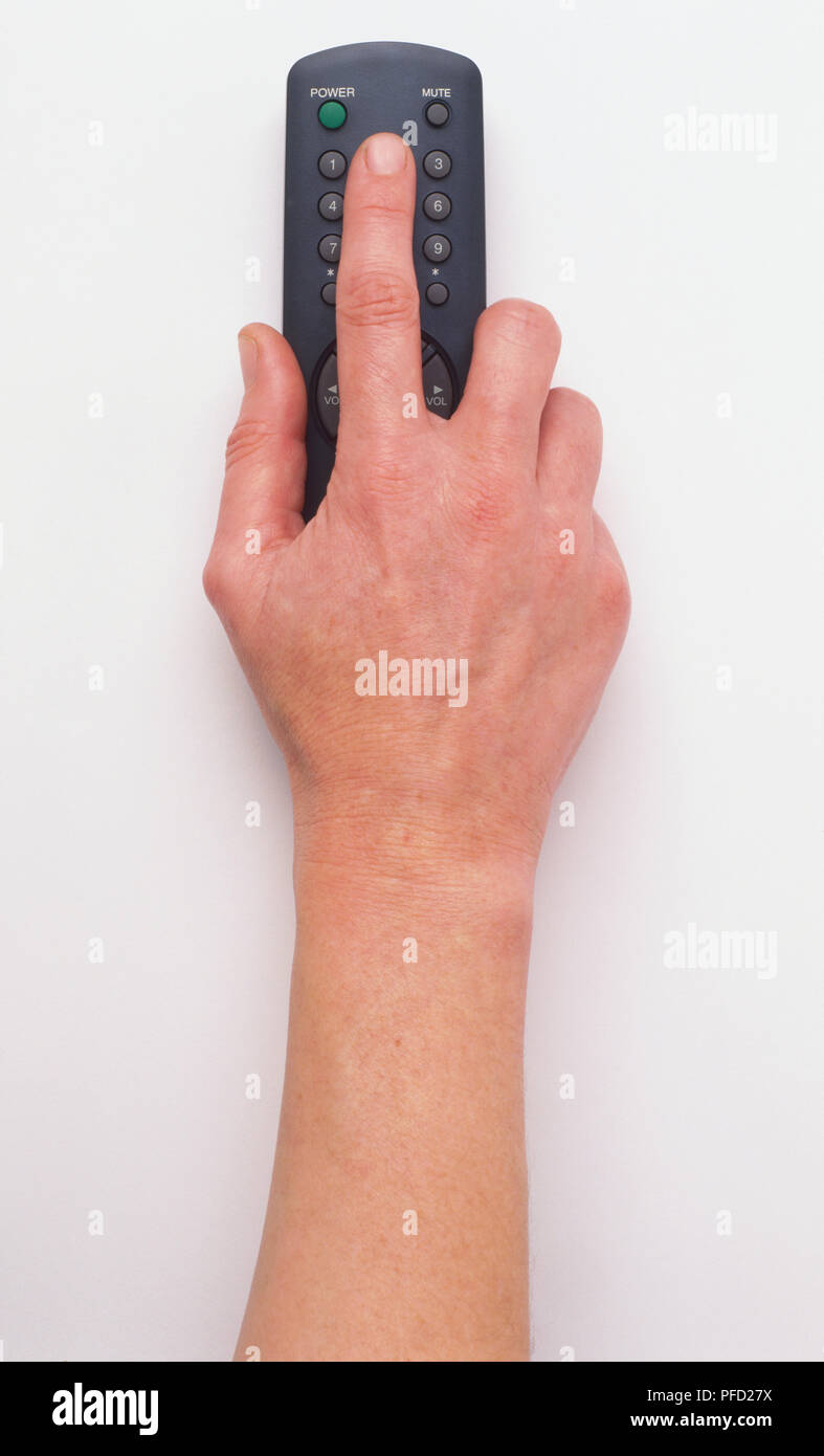 Finger on remote control button Stock Photo - Alamy