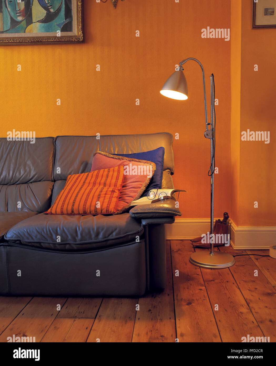 Modern floor-lamp standing next to sofa in living room Stock Photo - Alamy
