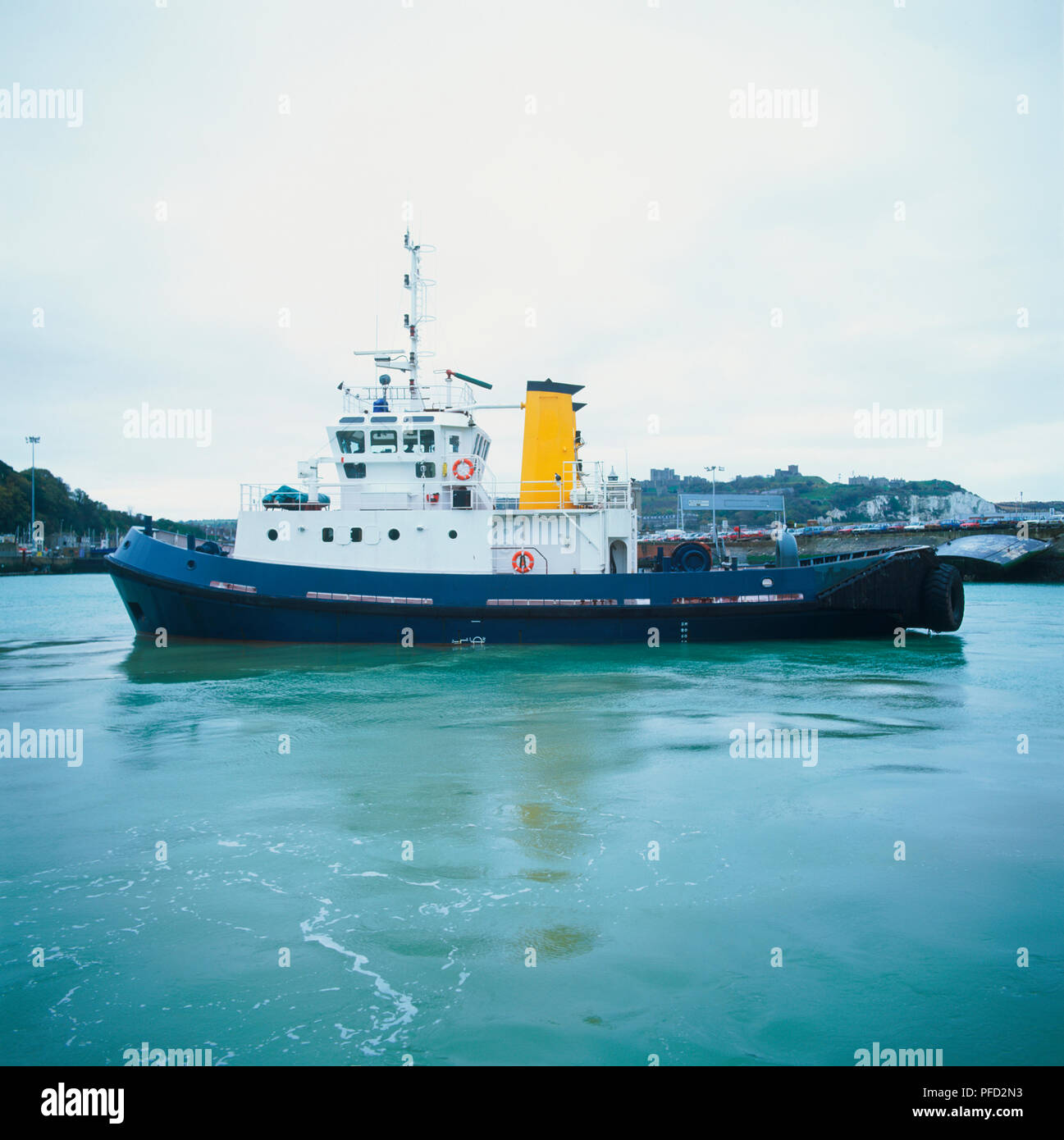 Large Tug Boat sailing on water, side view Stock Photo - Alamy