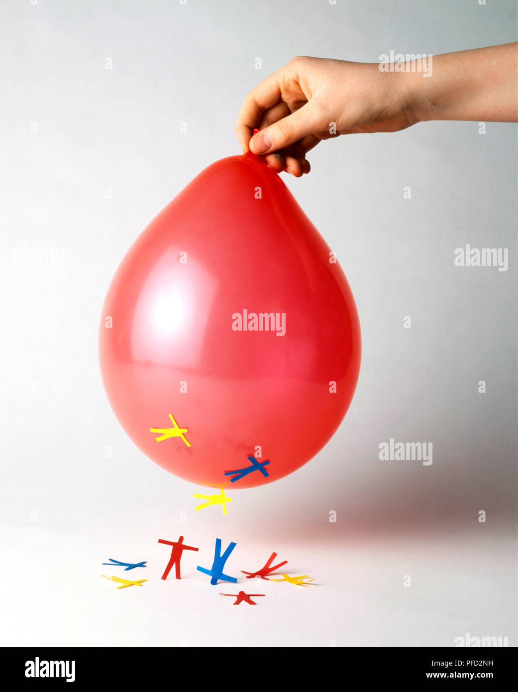 Hand picking up papermen with electrically charged balloon Stock Photo ...